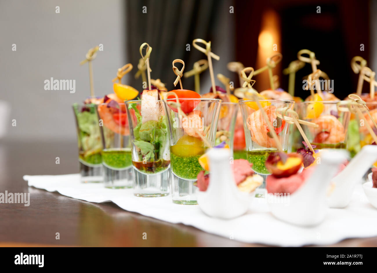 Various snacks in shot glasses, close-up Stock Photo - Alamy