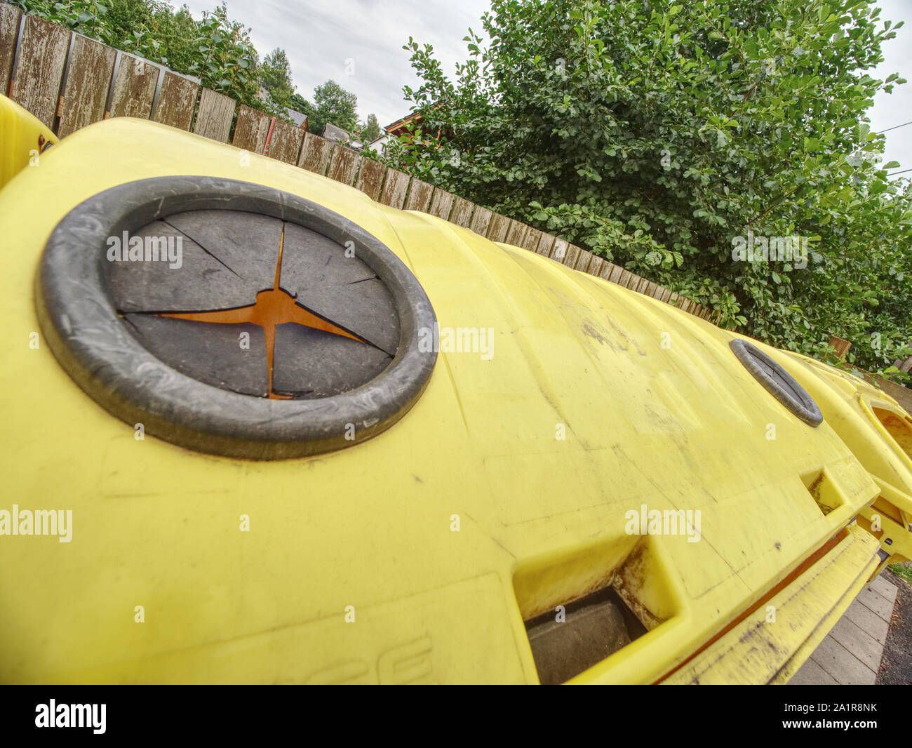 Yellow container for plastic materials used for recycling. Public place ...