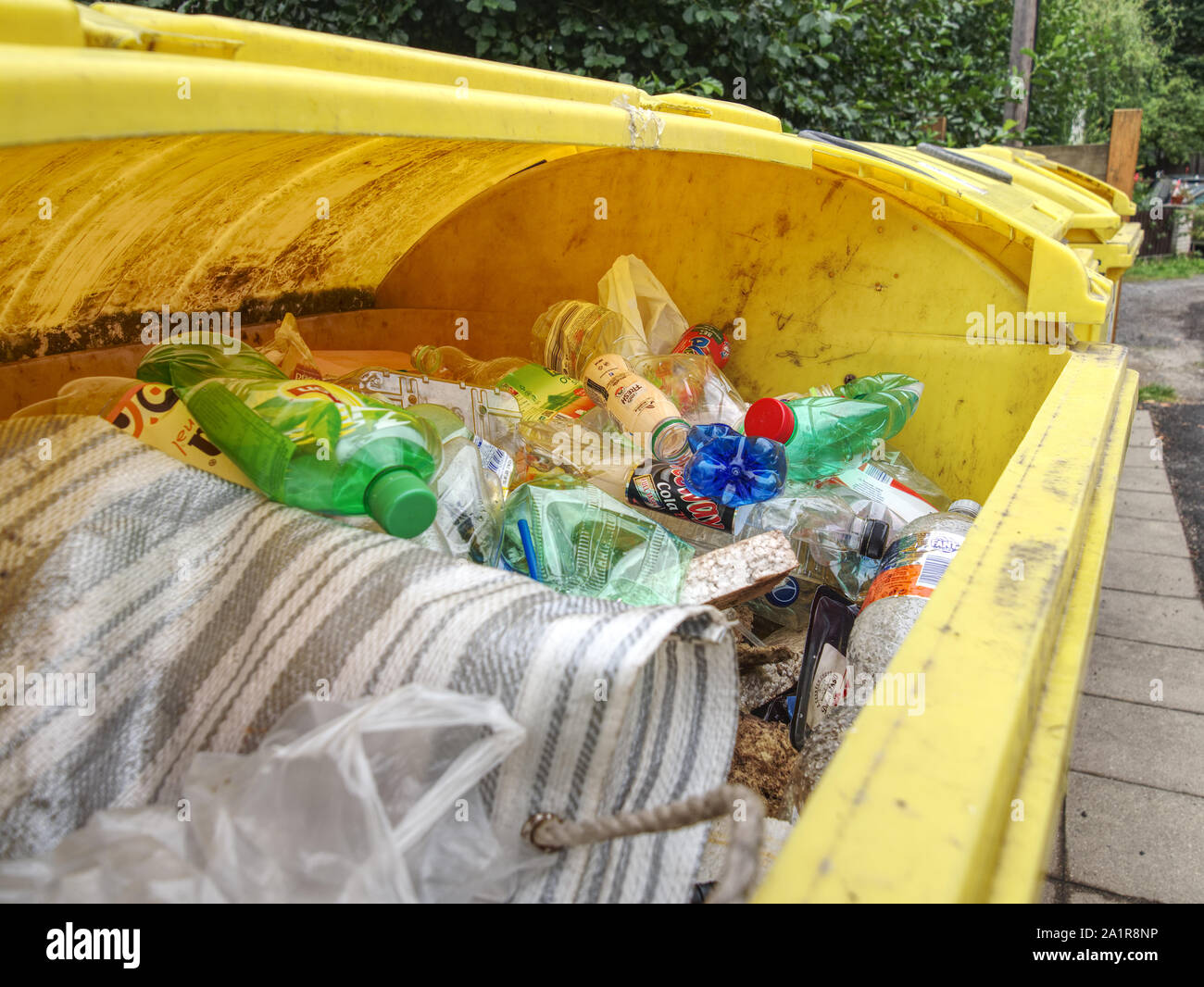 Yellow container for plastic materials used for recycling. Public place ...