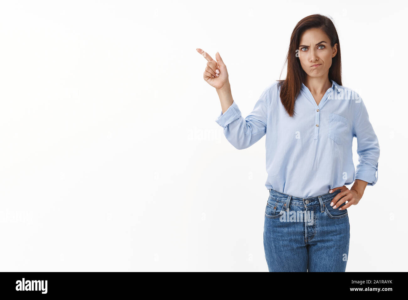 Disappointed angry serious-looking caucasian woman with tattooed arm ...