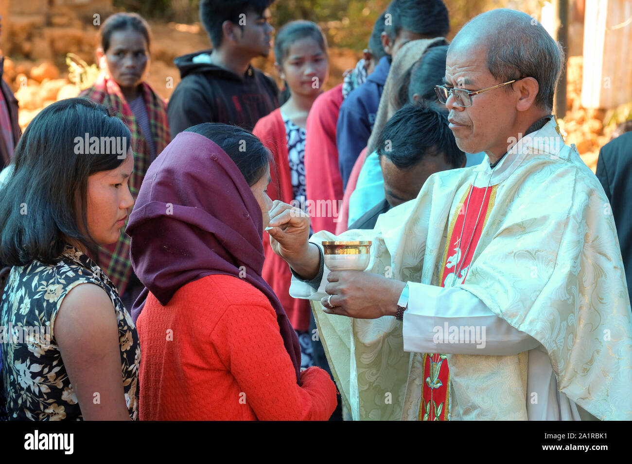 Catholic priest gives Holy Communion, Eucharist during a Catholic ...