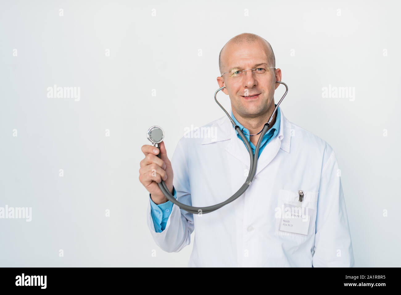 Smiling bald doctor with stethoscope looking at you before examination ...