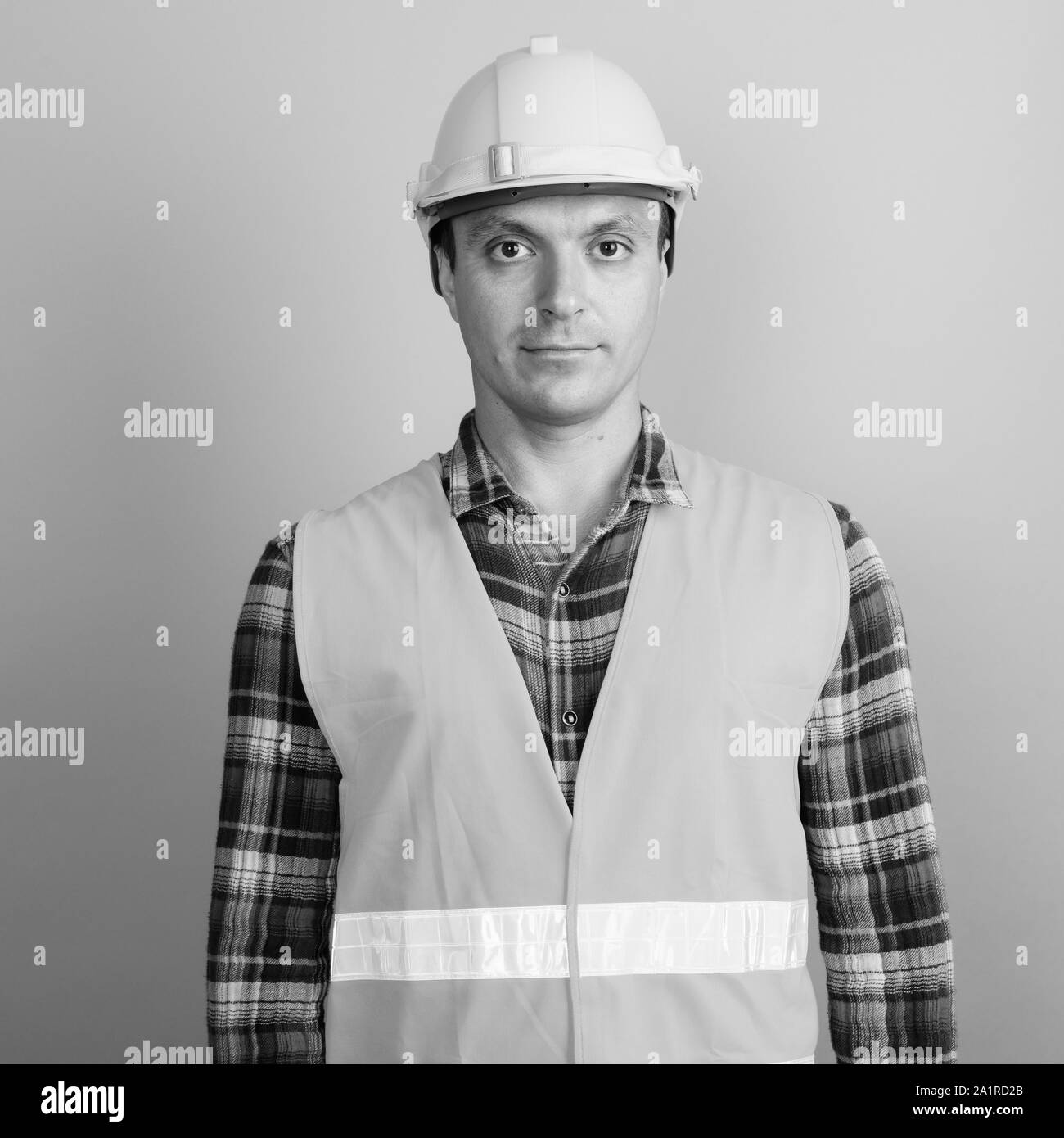 Man construction worker against gray background shot in black and white ...