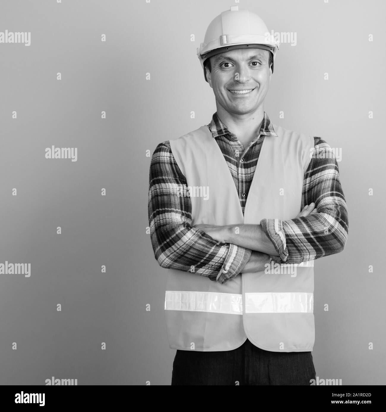 Man construction worker against gray background shot in black and white ...