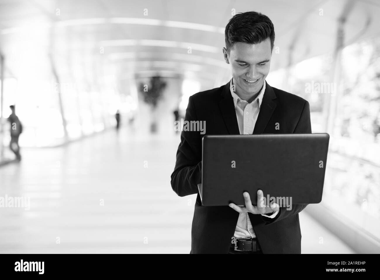 Handsome businessman laptop using Black and White Stock Photos & Images ...