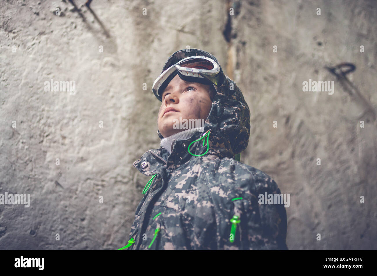 Serious girl in military uniform looking up. Disappointed and upset ...