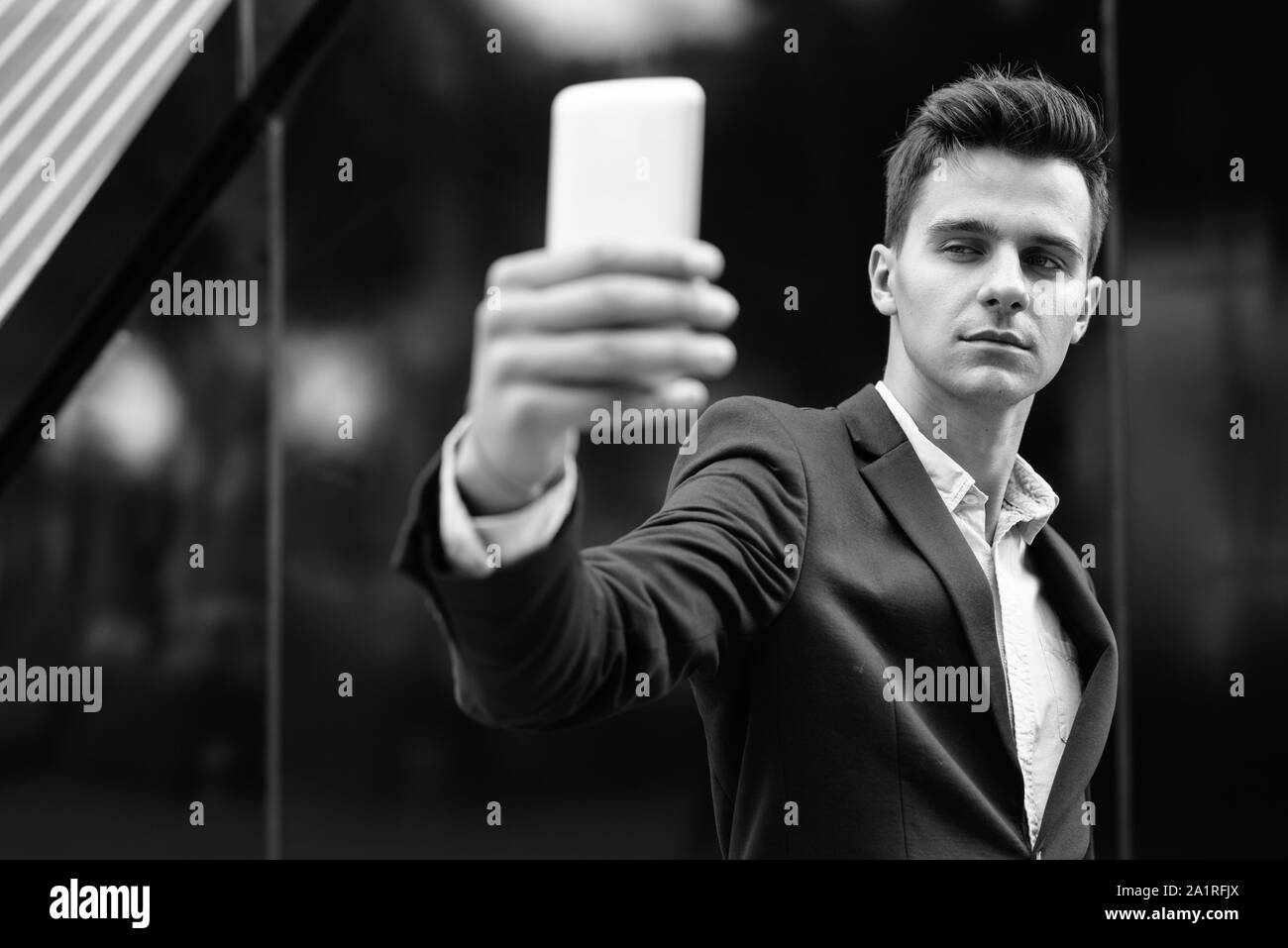 Young modern businessman using mobile Black and White Stock Photos ...