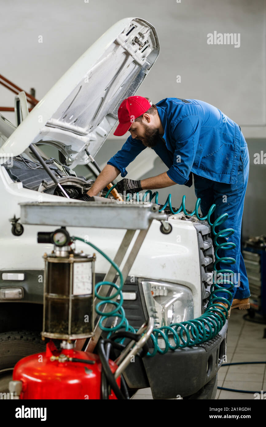Standing holding work tool auto repair shop transportation industry hi ...