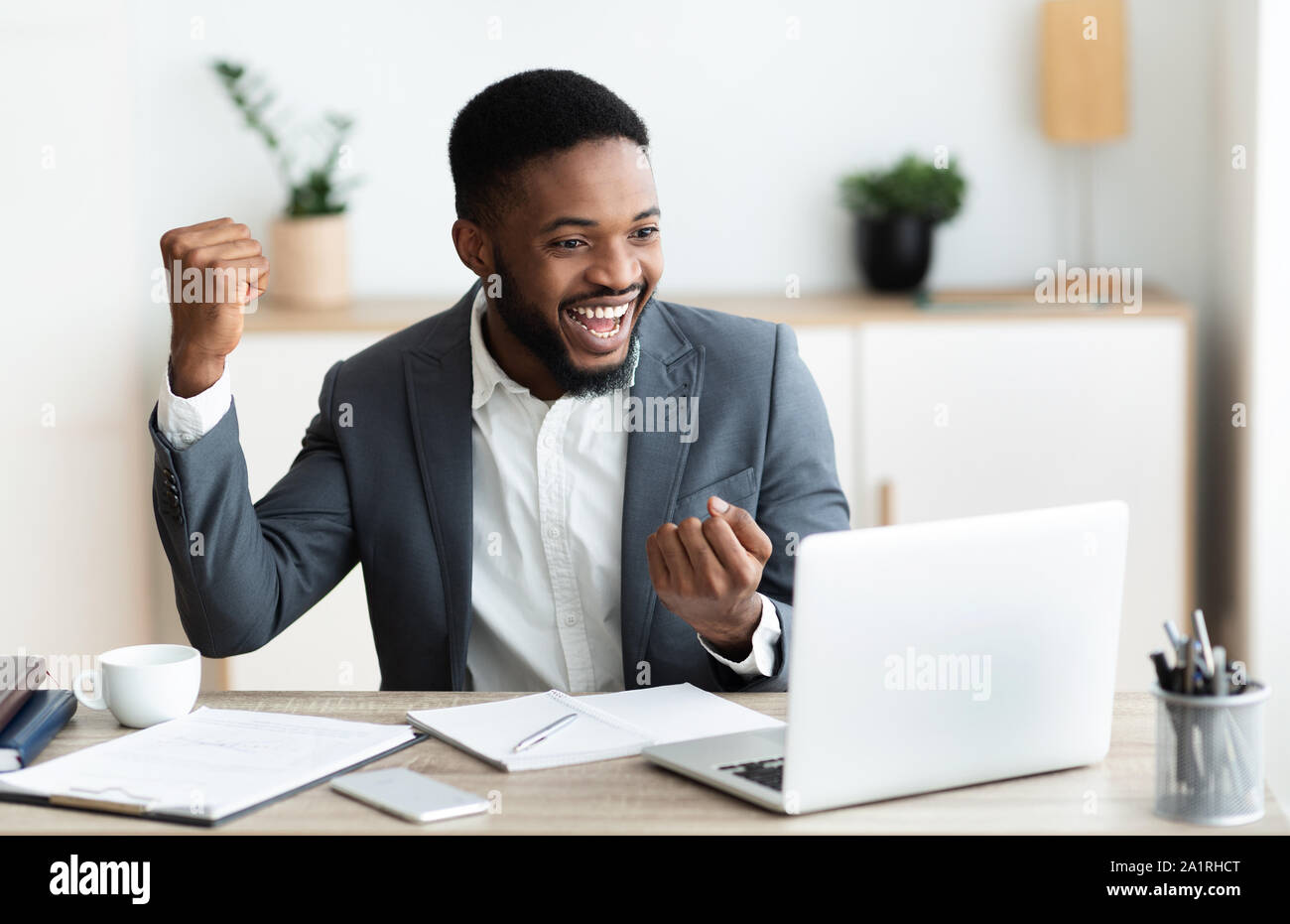 Happy black businessman rejoicing success at workplace in office Stock ...