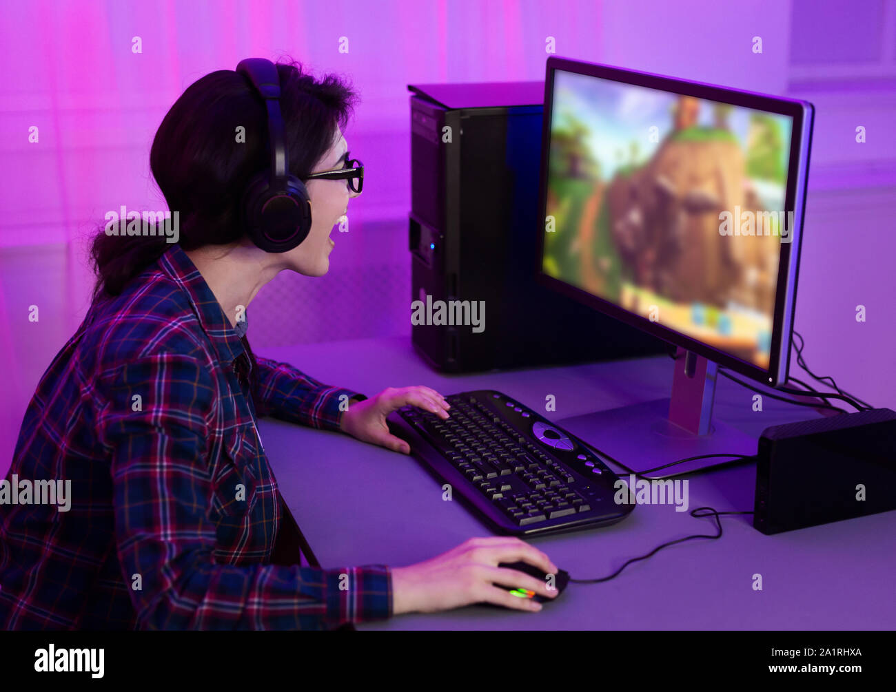 Addicted female gamer playing game online on computer Stock Photo - Alamy