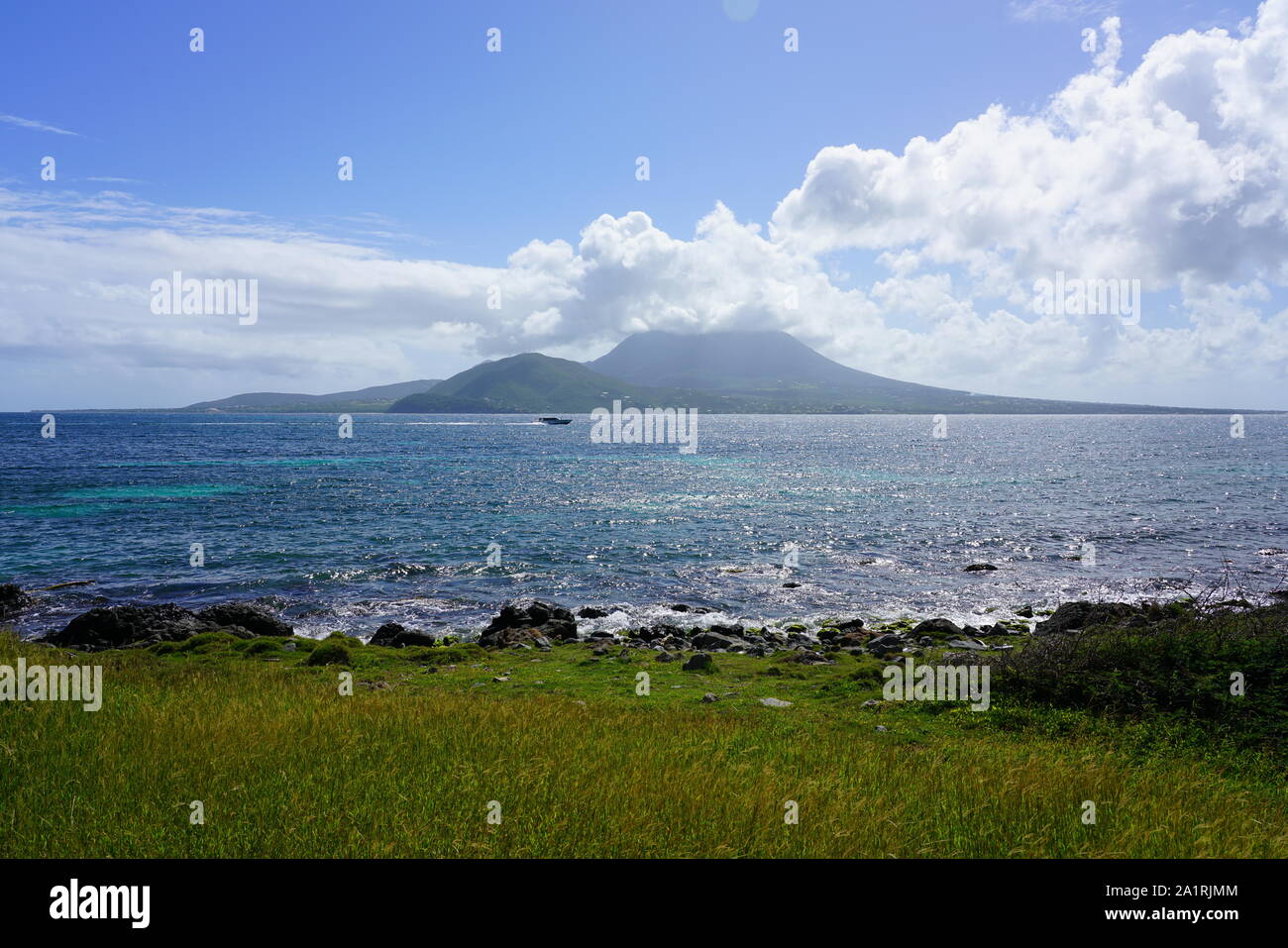 Day view of the Nevis Peak volcano across the water from St Kitts Stock ...