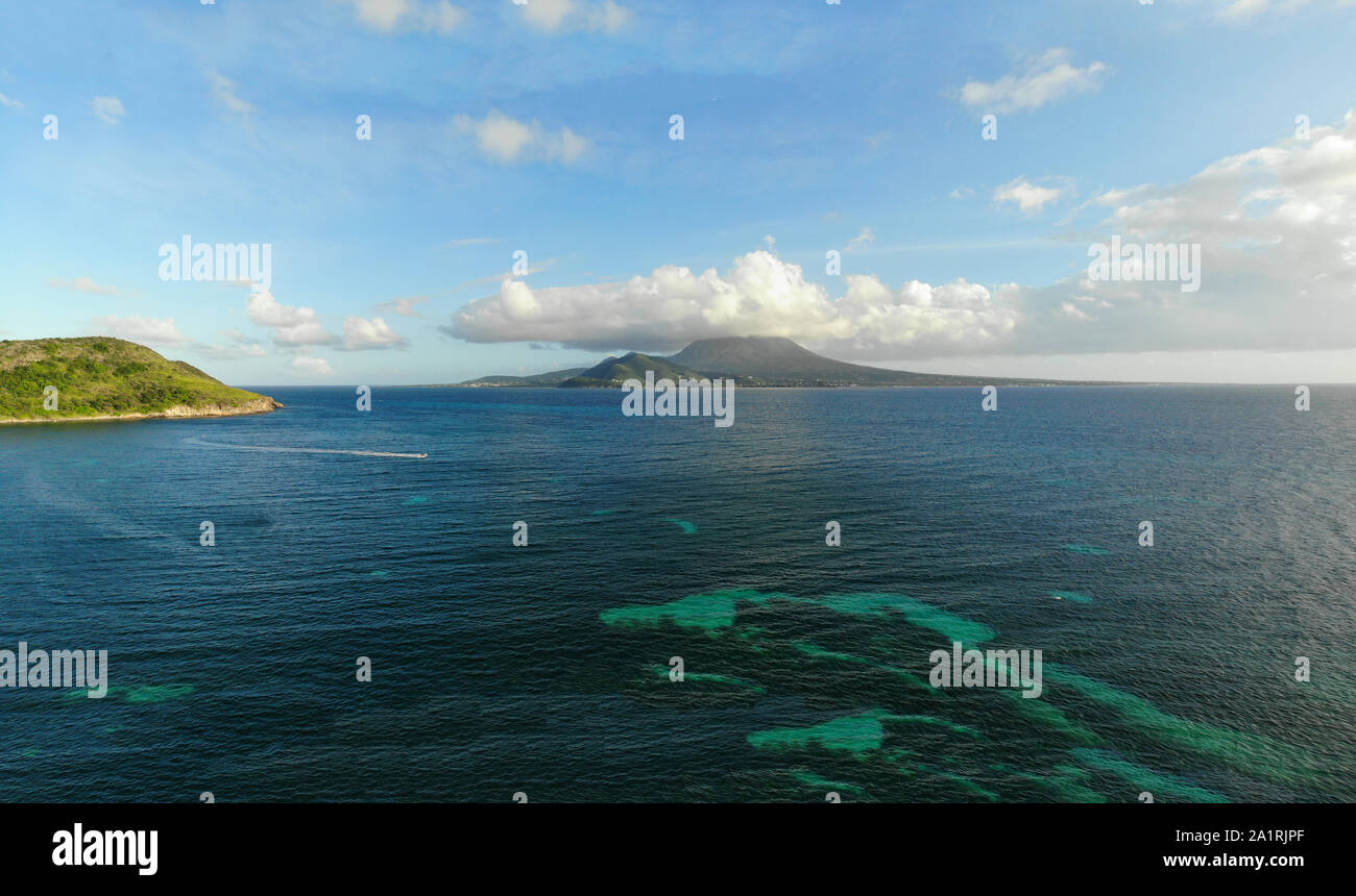 Day view of the Nevis Peak volcano across the water from St Kitts Stock ...