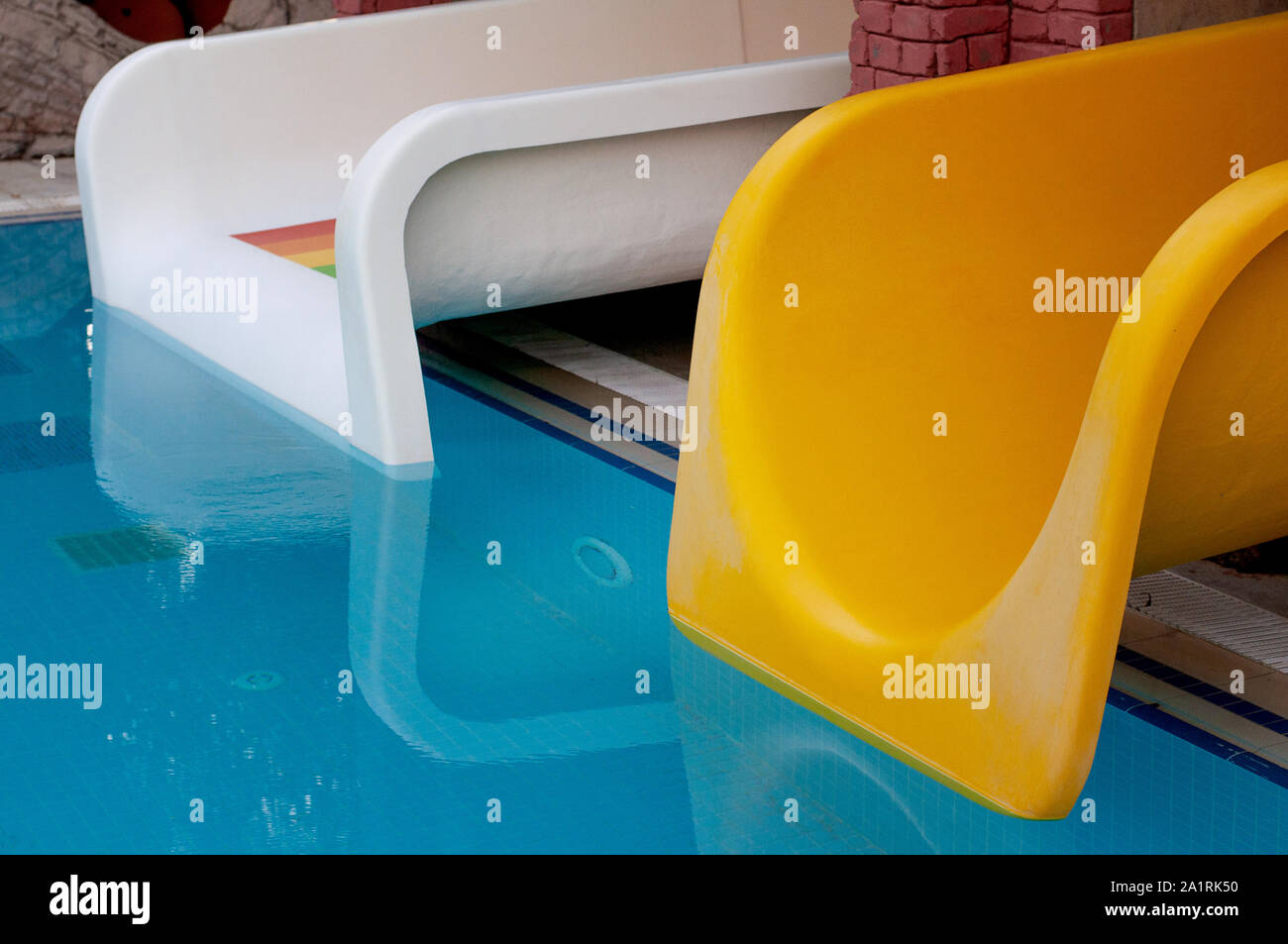 Yellow and white water slides by the pool. Active recreation on the ...