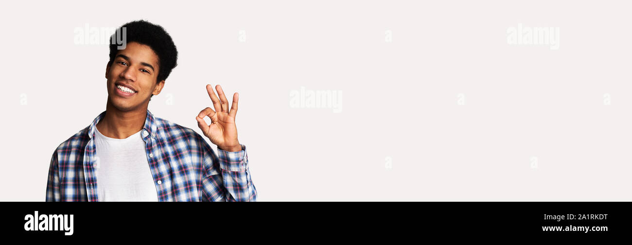 Excited african guy gesturing OK sign and smiling Stock Photo - Alamy