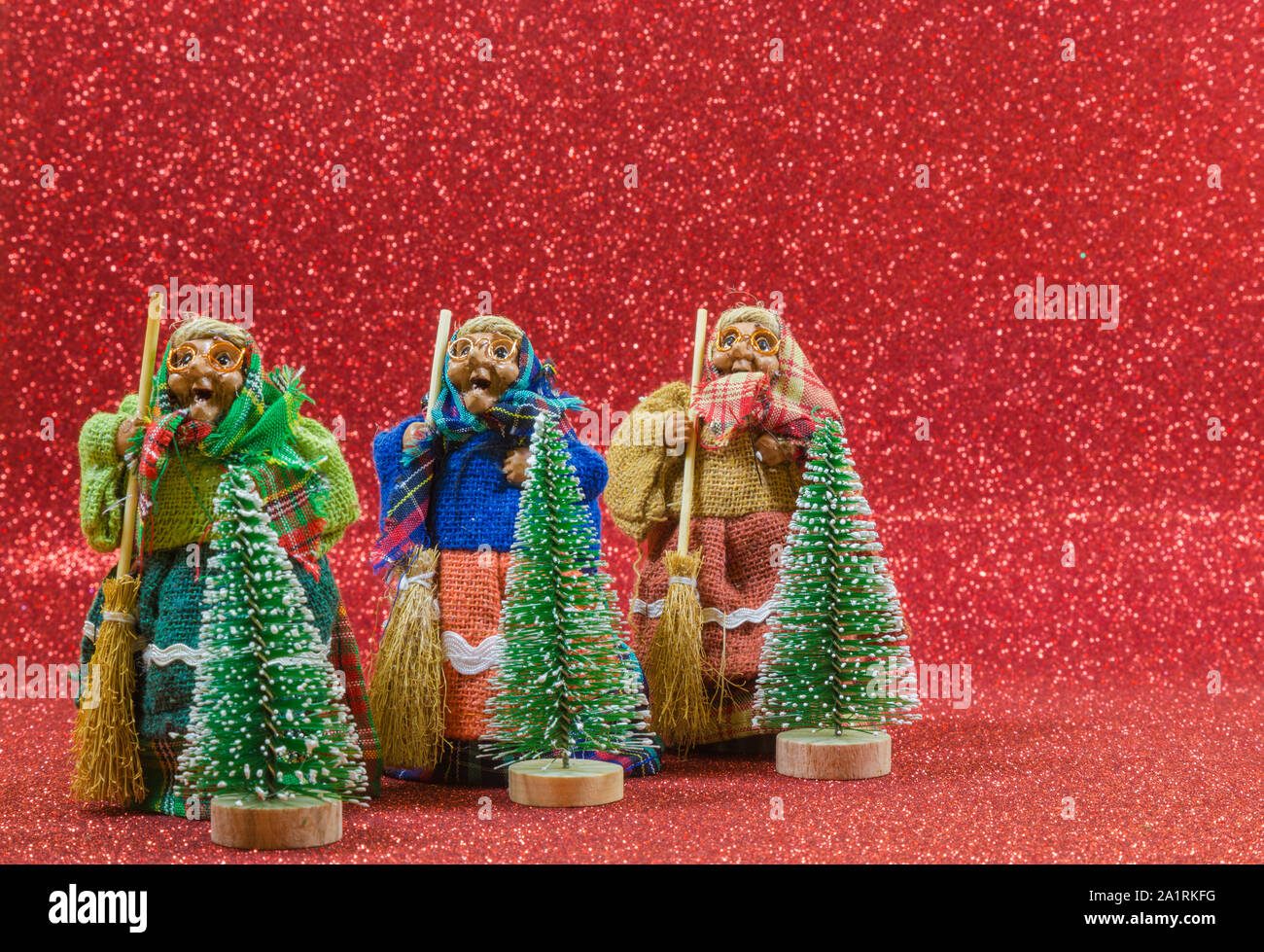Three old colored witches on a red background Stock Photo - Alamy