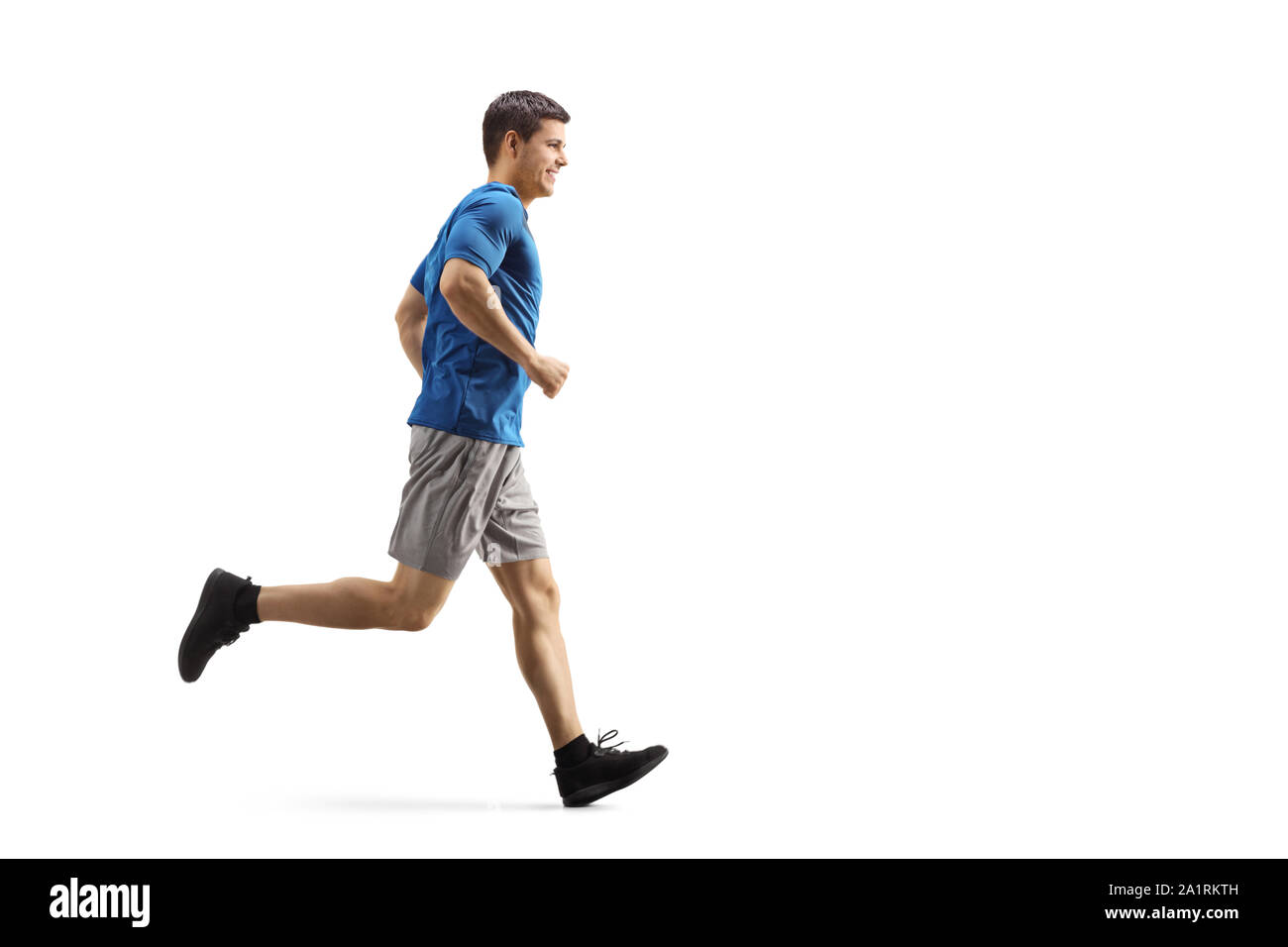Full length profile shot of a guy in sports clothes running isolated on ...
