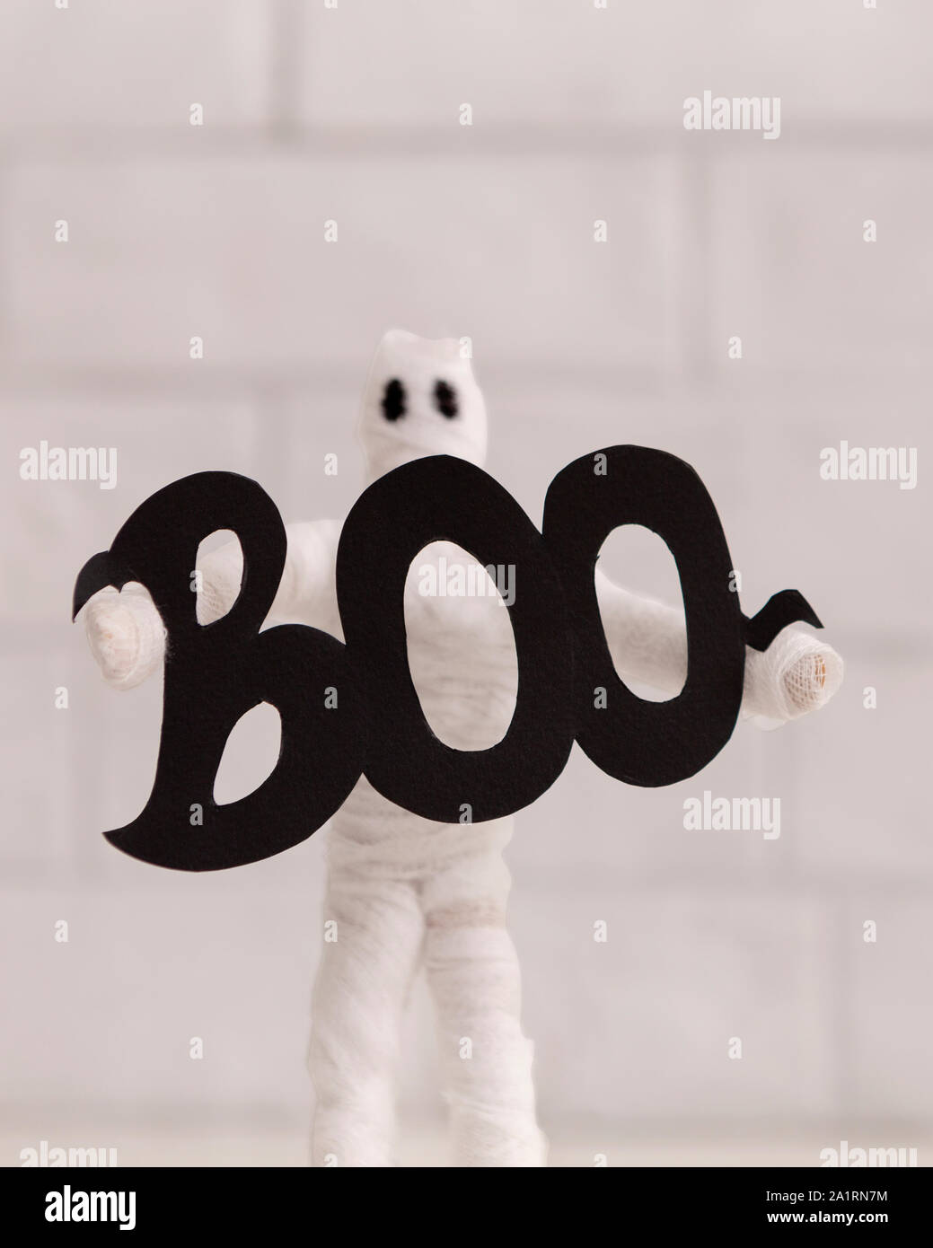 White ghost holding scary black text in hands on white Stock Photo - Alamy