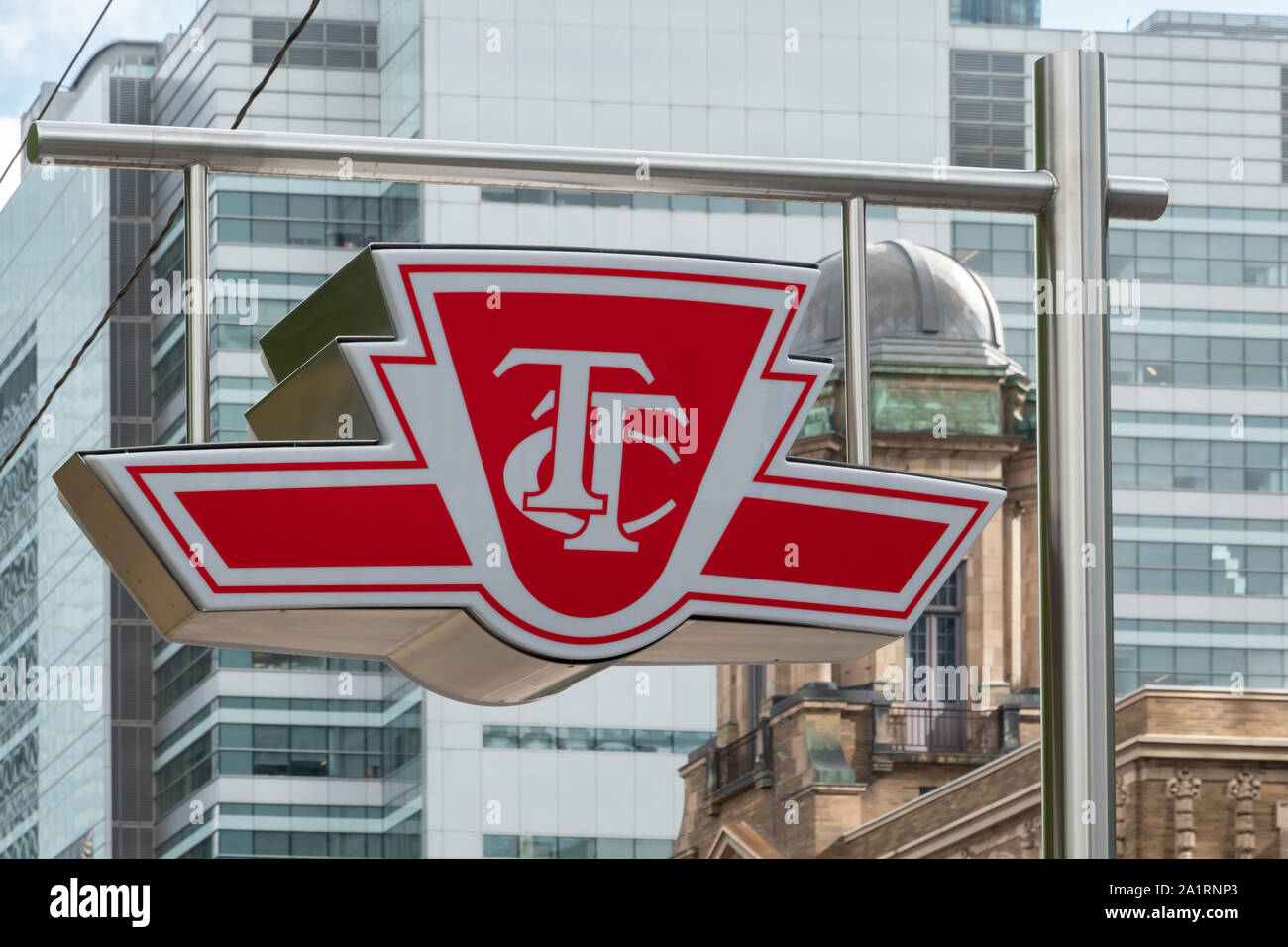Toronto Transit Commission sign with modern and older buildings in the ...