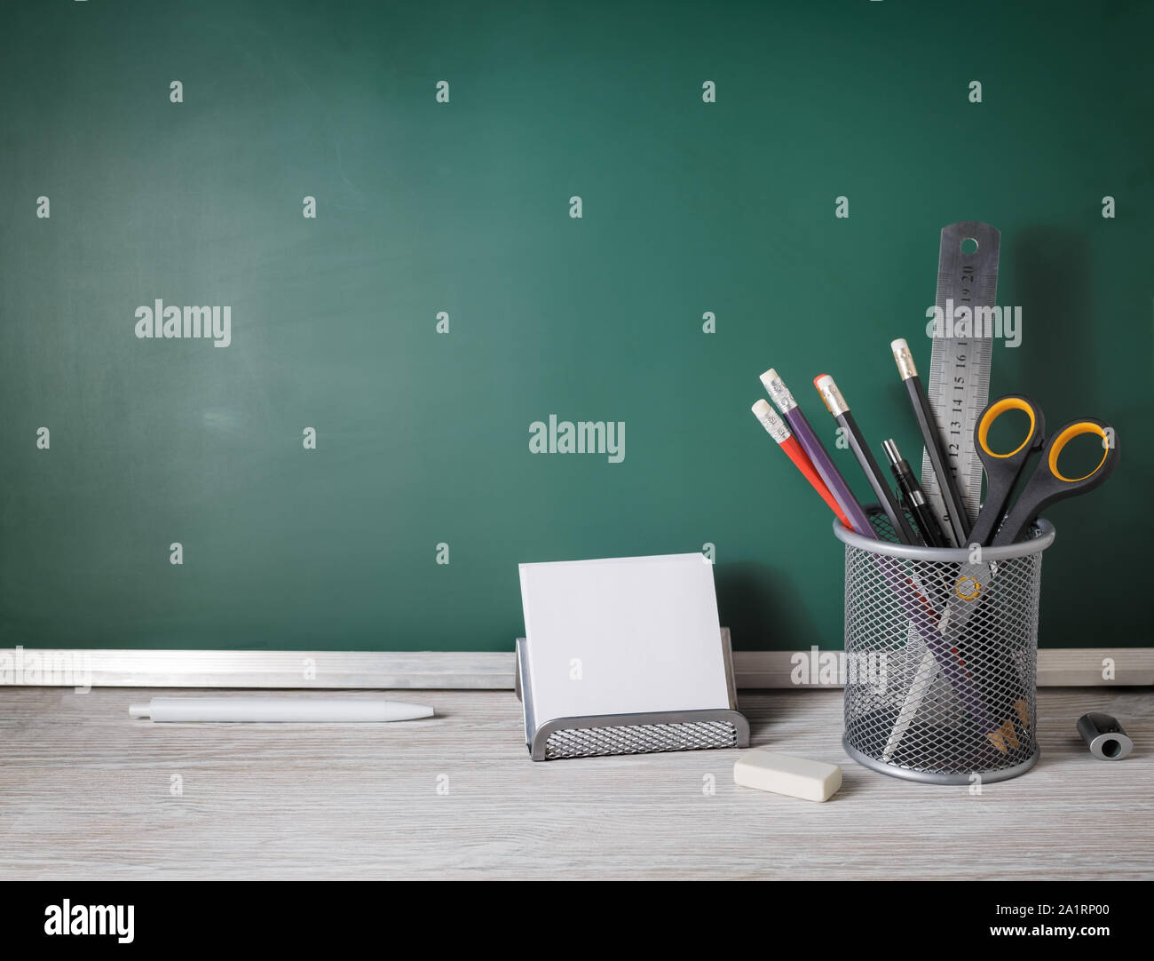 Blank school stationery over green blackboard background. Education ...