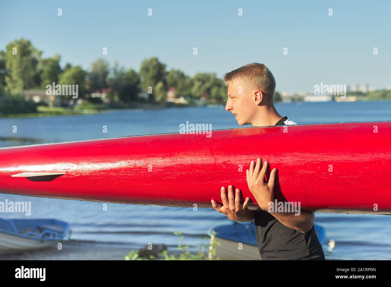 Boy teenager with sports boat kayak, teens walking with boat in their ...