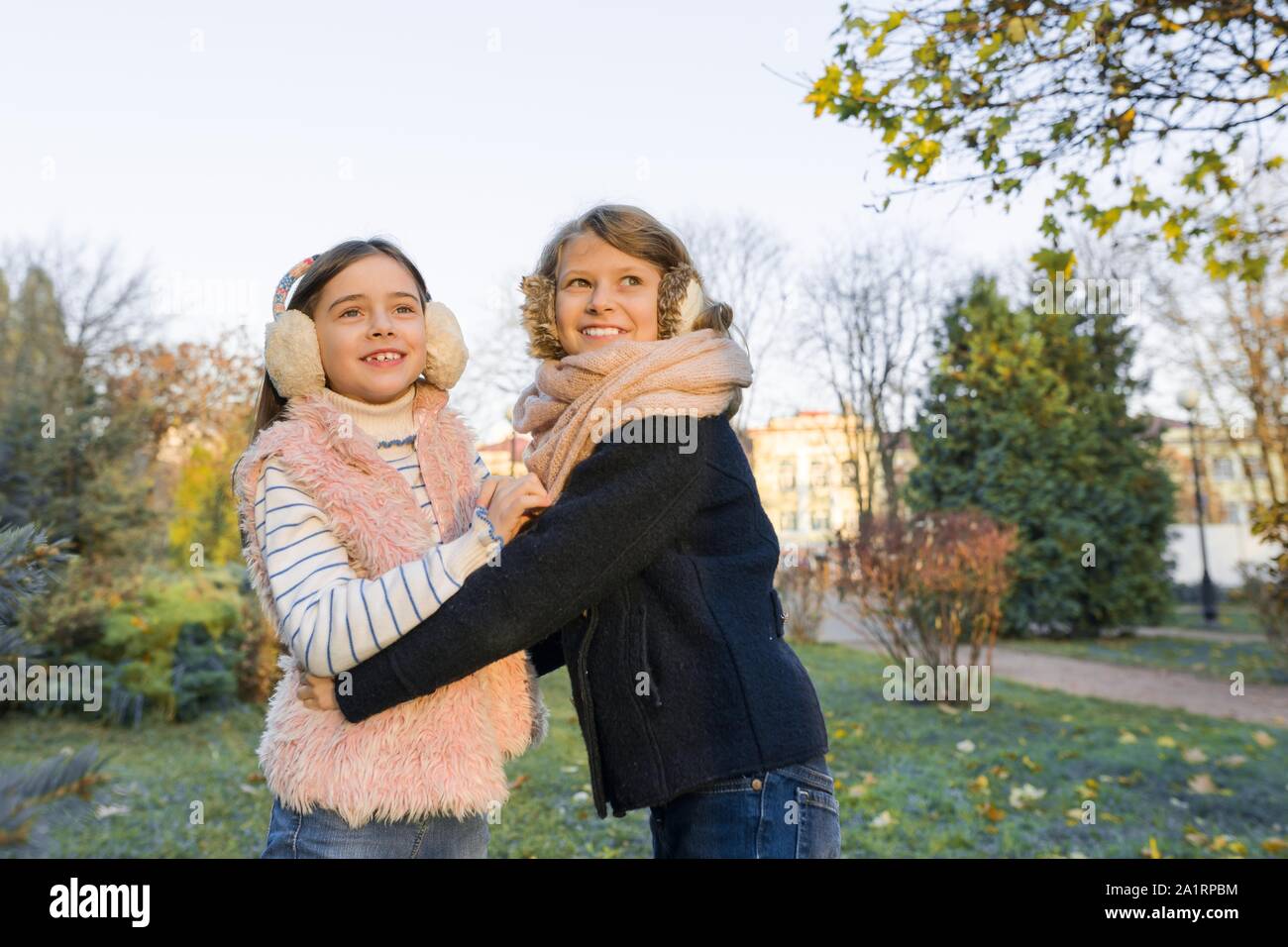 Outdoor portrait of two little girls best friends, smiling girls ...
