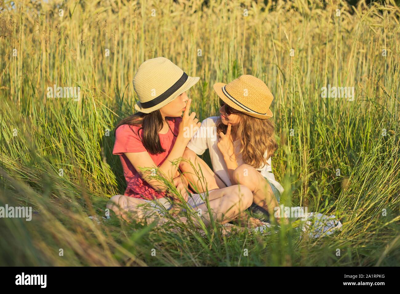 Children telling secrets hi-res stock photography and images - Alamy