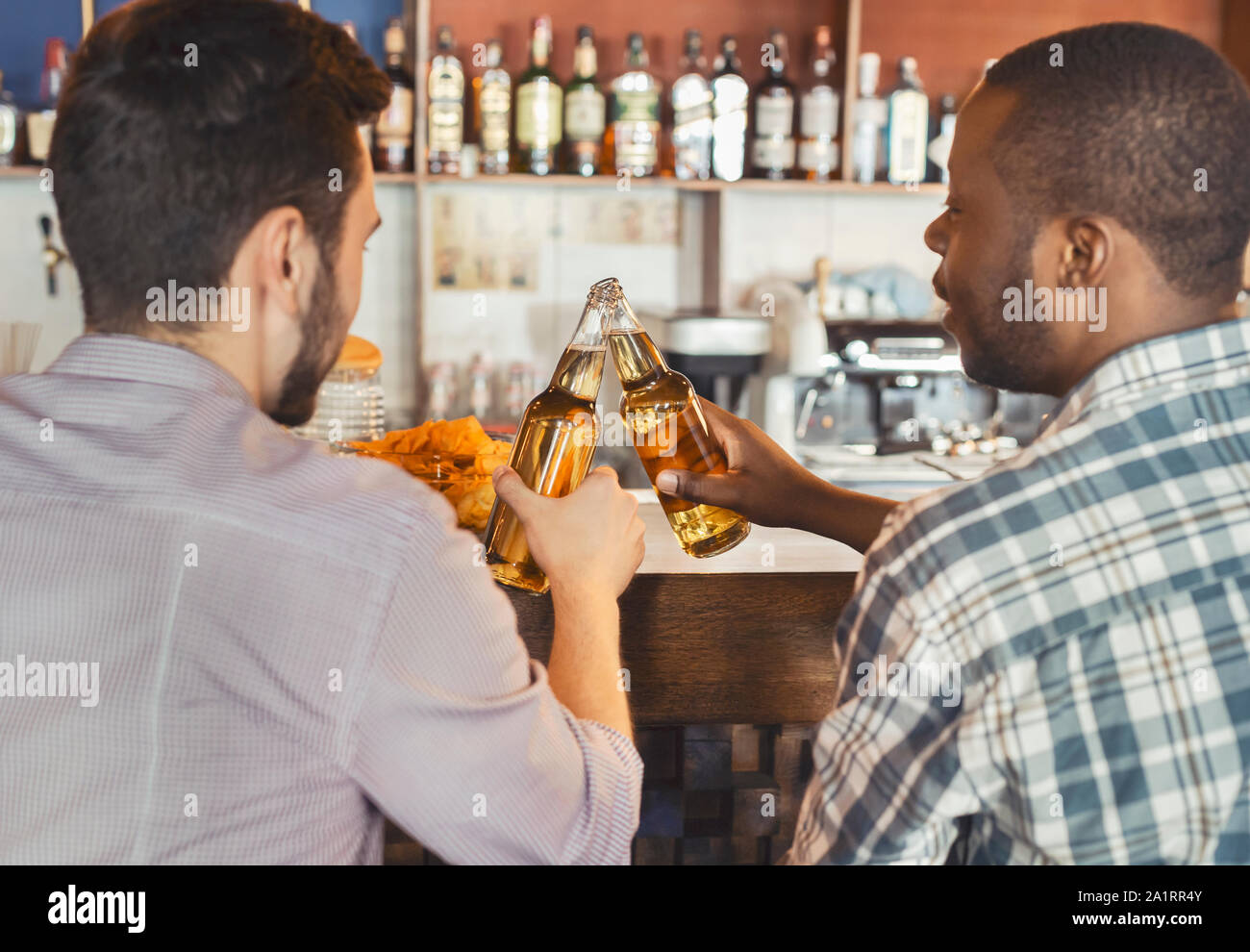 Two guys sit bar clinking hi-res stock photography and images - Alamy