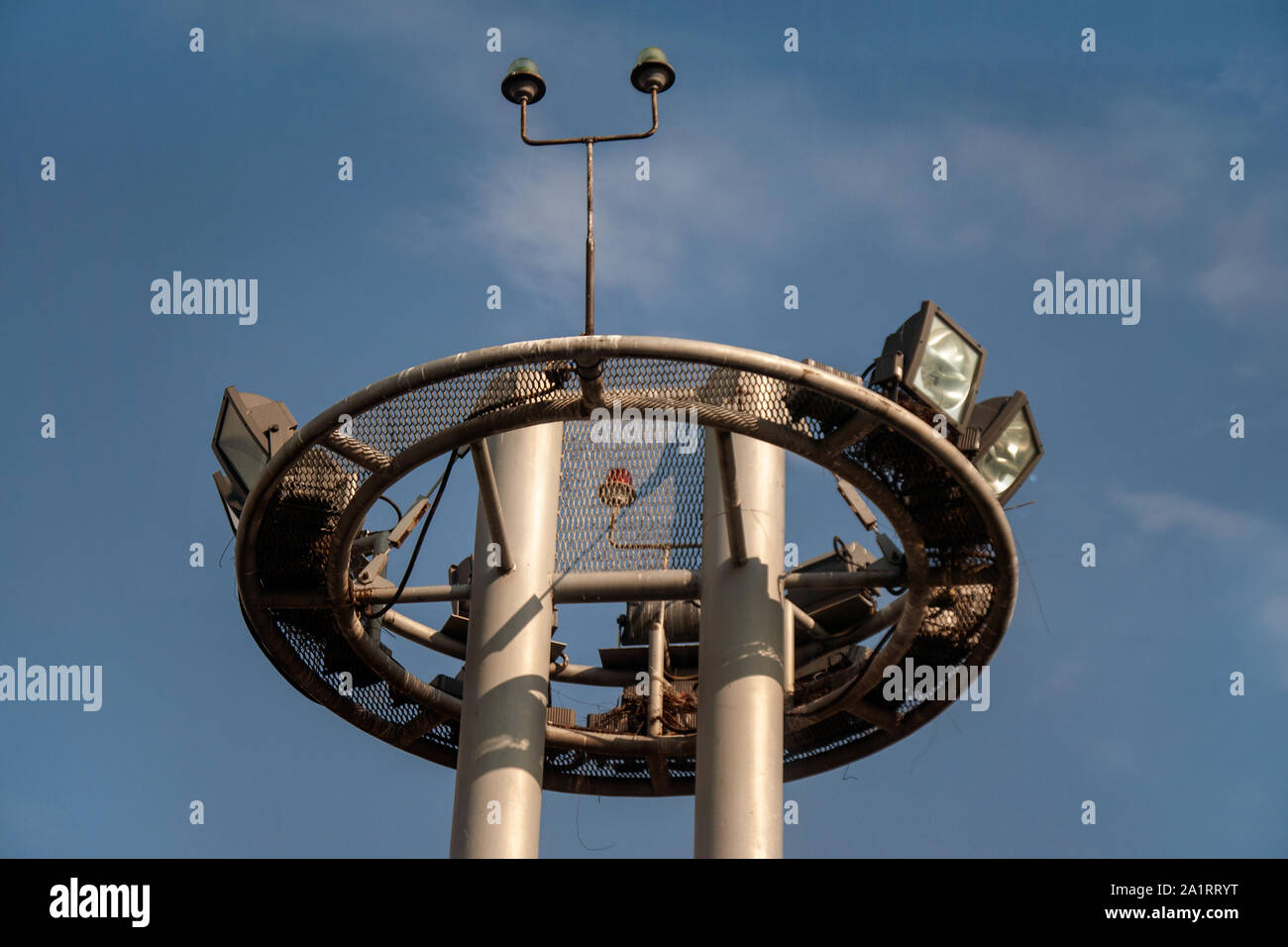 Tower of lighting and equipment at the airport against the blue sky ...