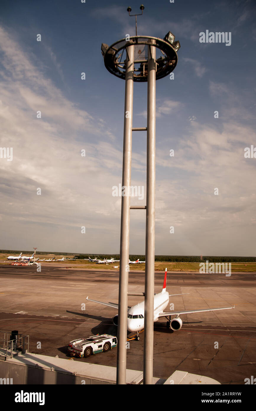 Tower of lighting and equipment at the airport on a background of blue ...