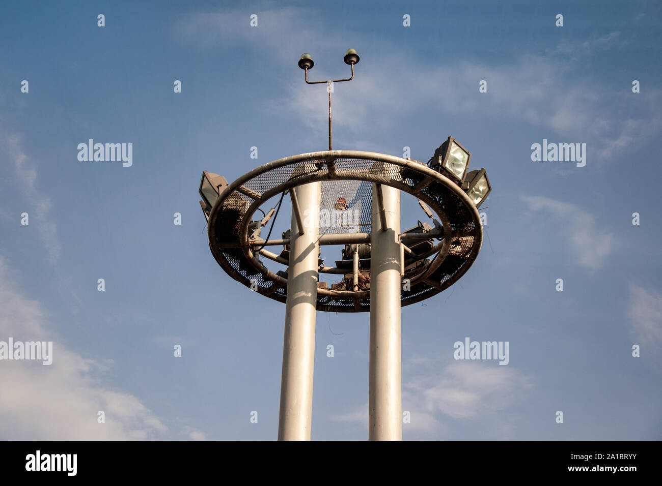 Tower of lighting and equipment at the airport against the blue sky ...