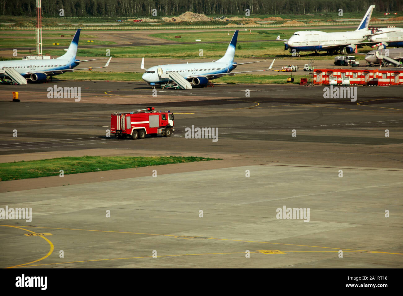 Fire truck on the runway near the aircraft. Airport Rescue Service ...
