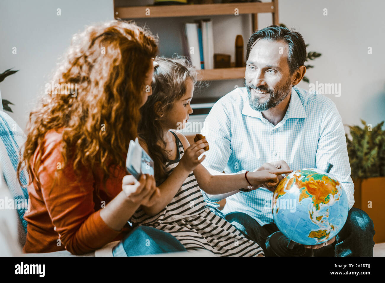Family travel, parents with little daughter preparing to go on vacation ...