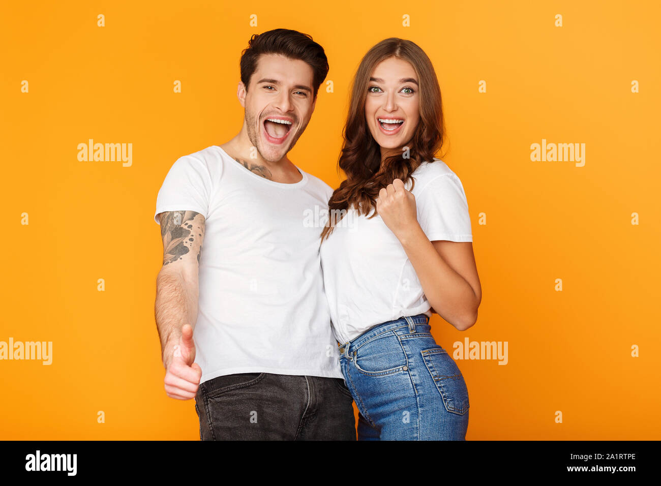 Happy couple rejoicing success, exclaiming with triumph Stock Photo - Alamy