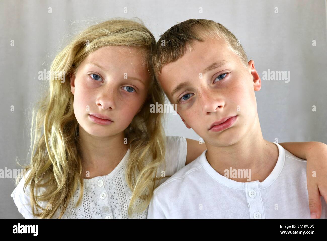Portrait of two tired, disappointed, damaged siblings Stock Photo - Alamy