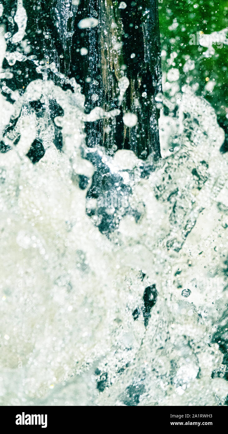 Water backgrounds with foam spray fast flow.The log is stuck in ...