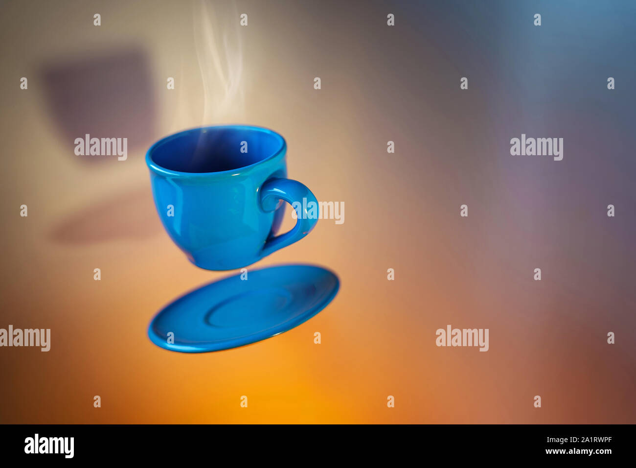 Floating blue cup of espresso. Mock up of soaring in the air cup of hot ...