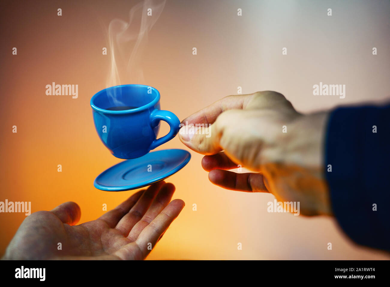 Floating blue cup of espresso with hands. First-person view. Mock up of ...