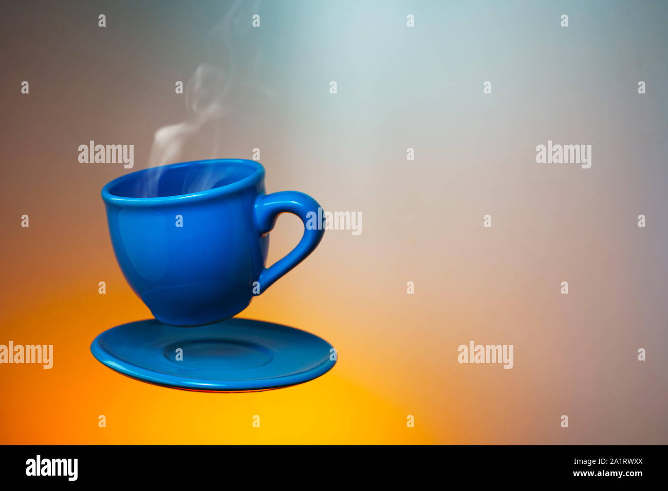 Floating blue cup of espresso. Mock up of soaring in the air cup of hot ...