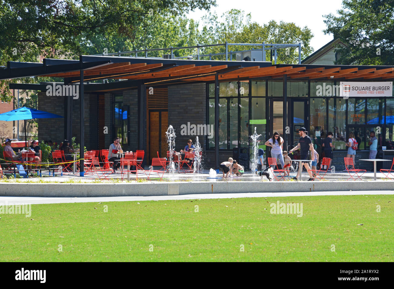 Children play in the dancing fountain at the revitalized Moore Square ...