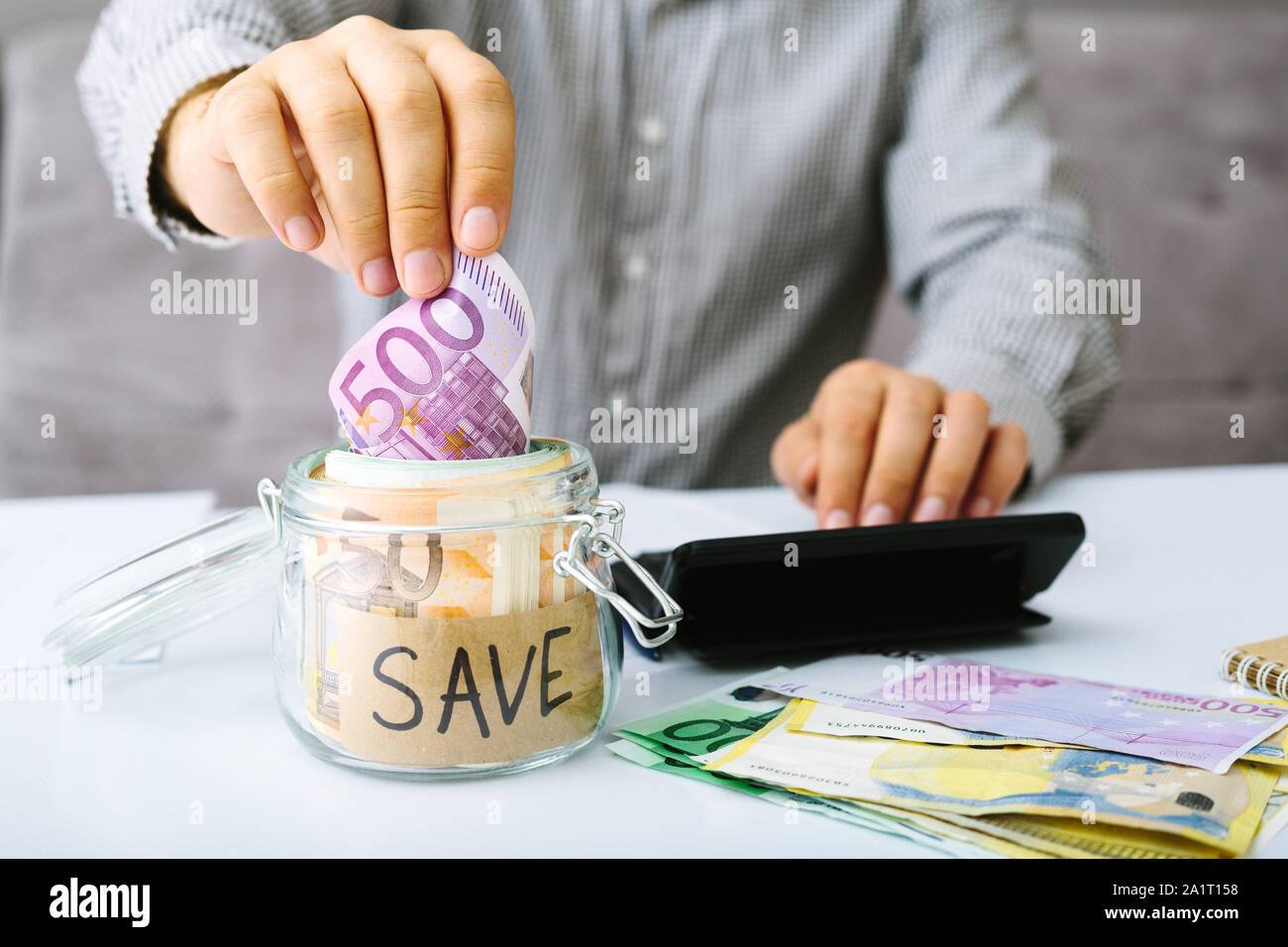 Hand holding money putting glass hi-res stock photography and images ...