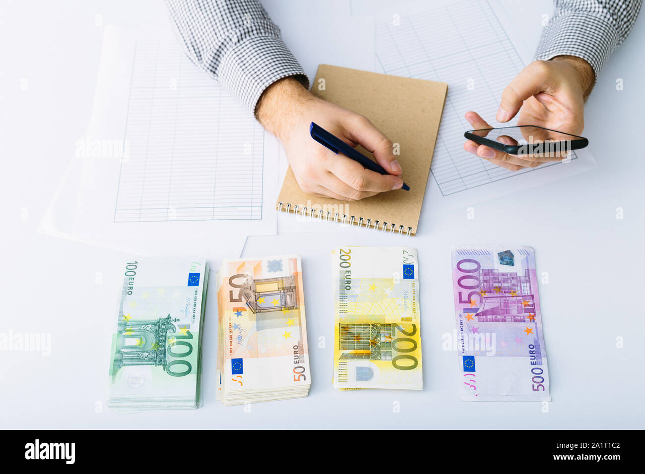 Euro banknotes are stacked. Man doing his accounting. Distribution of ...