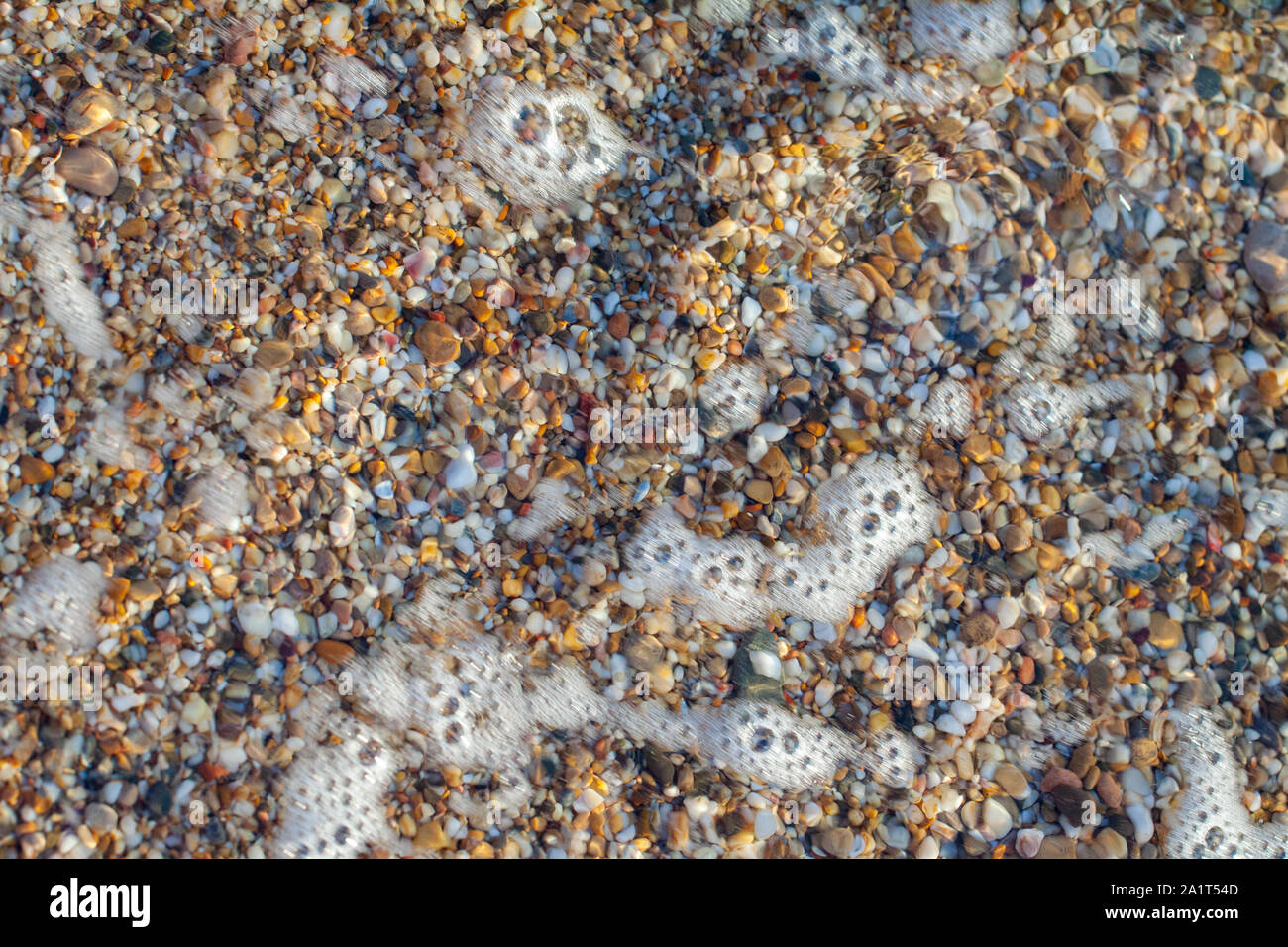 sea pebbles colored granite on the beach background stones. The shore ...