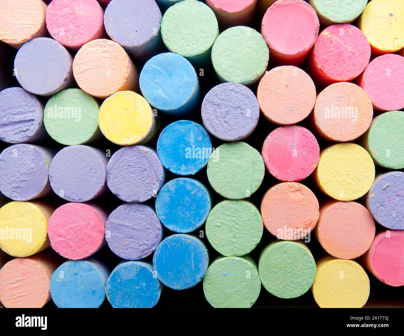 row of colored chalk on black background Stock Photo - Alamy