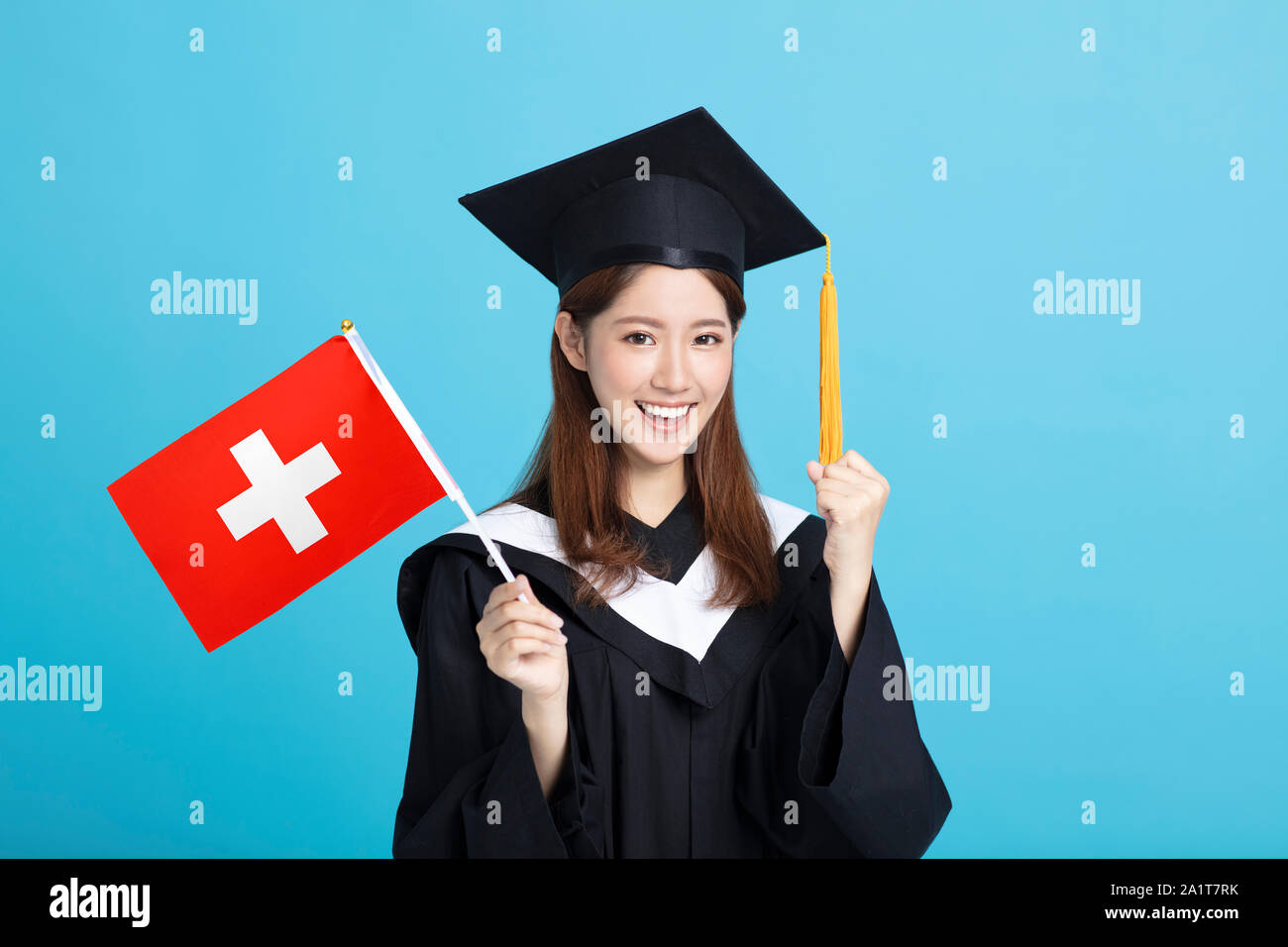 happy Young female graduation student showing the Switzerland flag ...