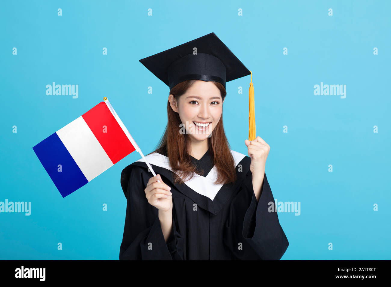 happy Young female graduation student showing the France flag Stock ...