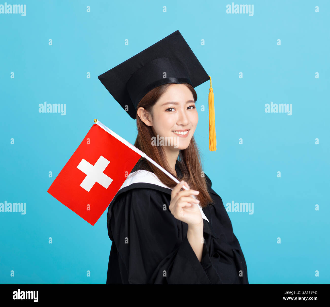 happy Young female graduation student showing the Switzerland flag ...