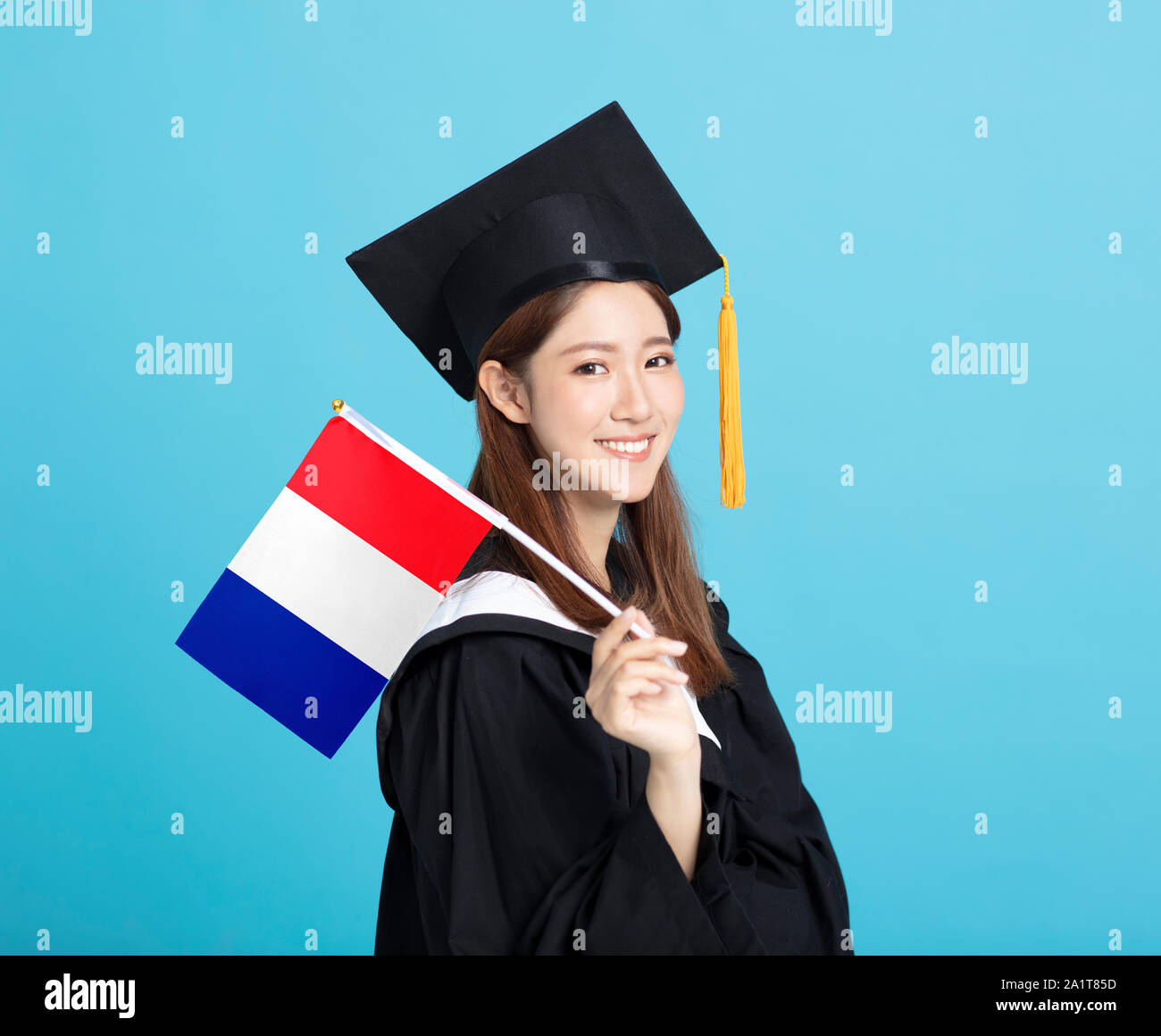 happy Young female graduation student showing the France flag Stock ...