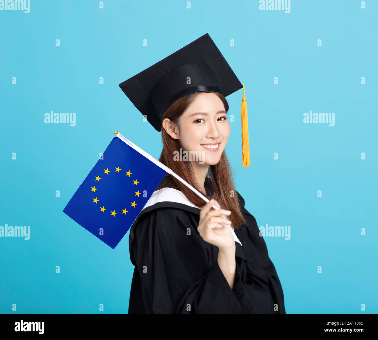 happy Young female graduation student showing the European Union flag ...