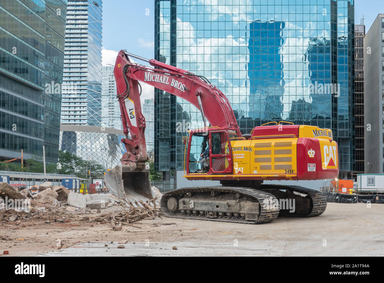 Excavator working at a construction site in downtown Toronto Ontario ...