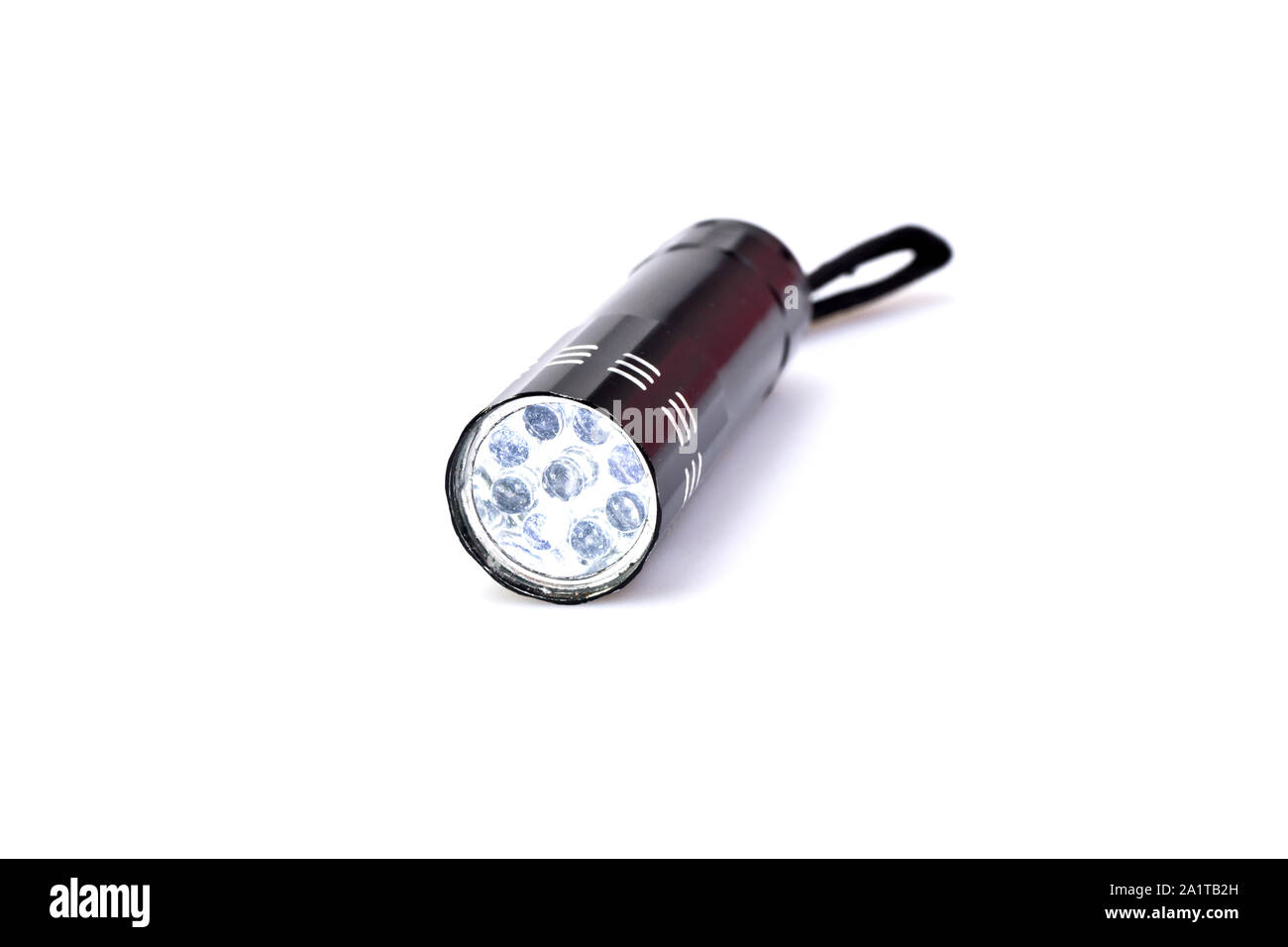 black LED torchlight on white background with LED lights turned on ...